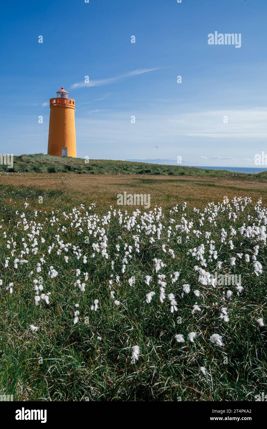 Holmsberg Lighthouse, an orange light house on the Reykjanes Peninsula ...
