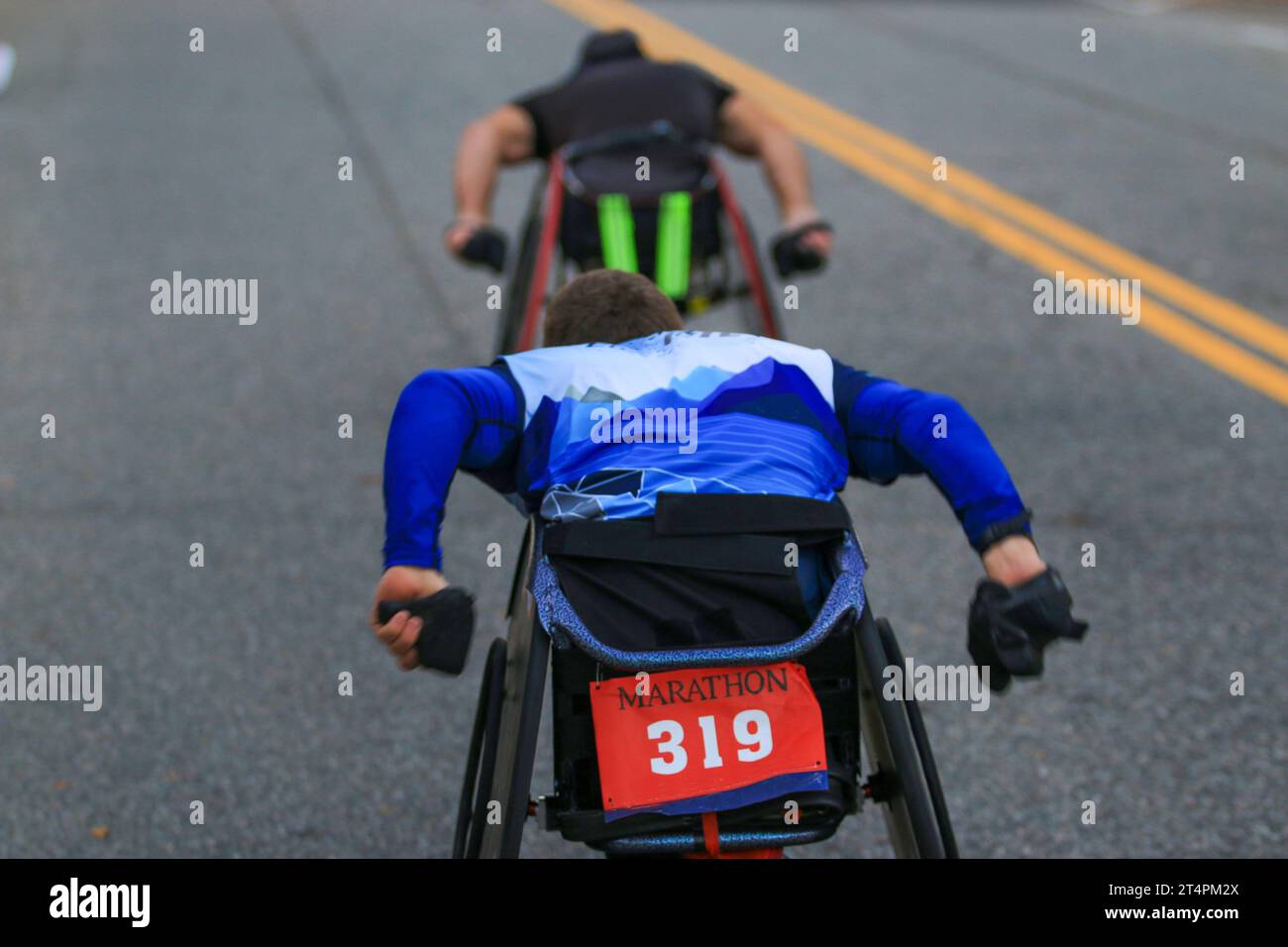 Wheelchair athletes racing in a marathon on the roads in Suffolk County ...