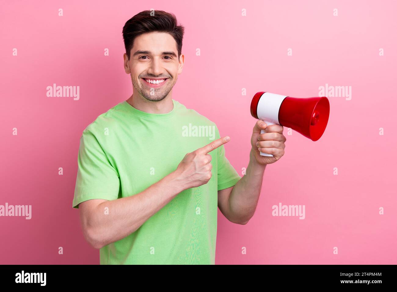 Photo smiling young man hold loudspeaker finger pointing his tool to ...