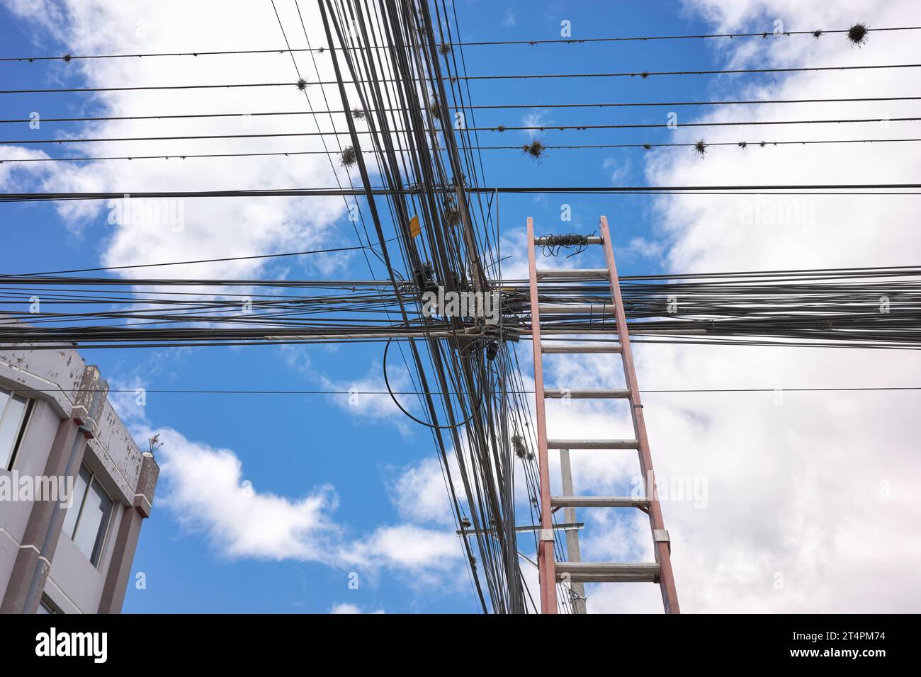 Ladder by crossing cables against the sky, Otavalo, Ecuador Stock Photo ...