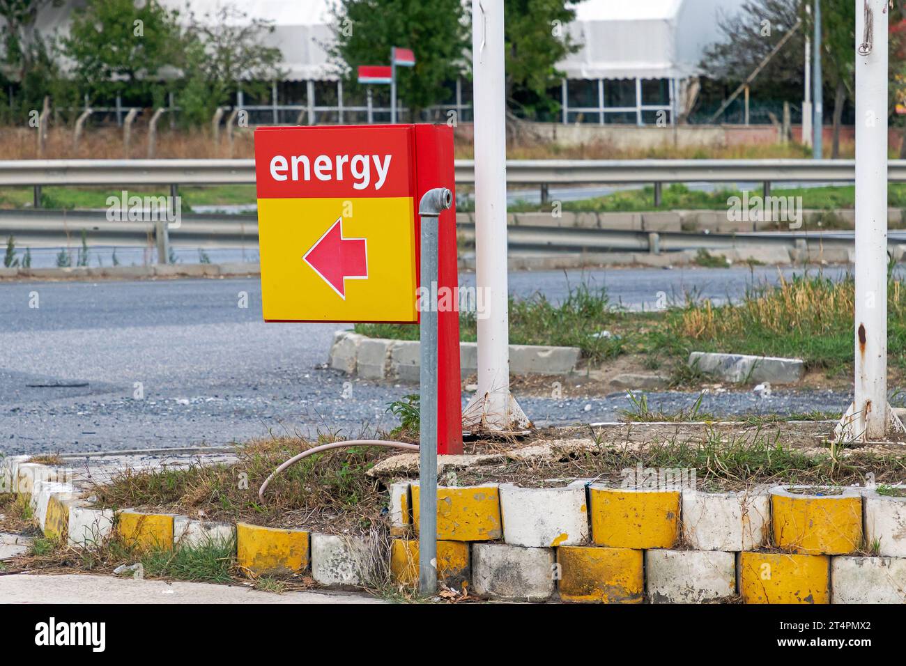 Traffic sign for direction to closest gasoline station on urban road ...