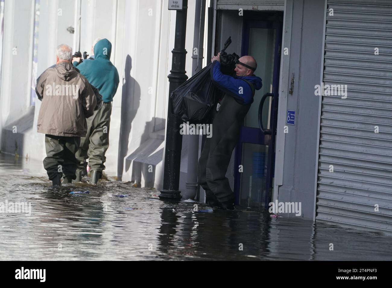 People clear out damaged shops in Sugar Island, Newry Town, Co Down ...