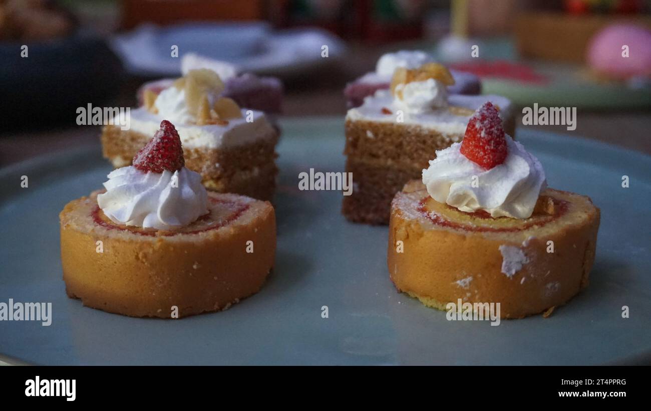 Small cakes with beautiful and fresh toppings, layer cakes and rolled ...