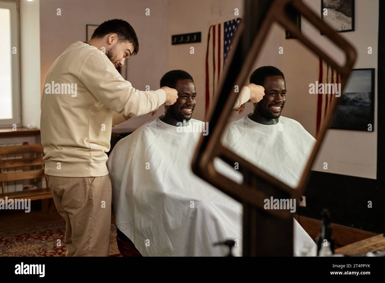 African American young man cutting his hair in barber shop Stock Photo ...