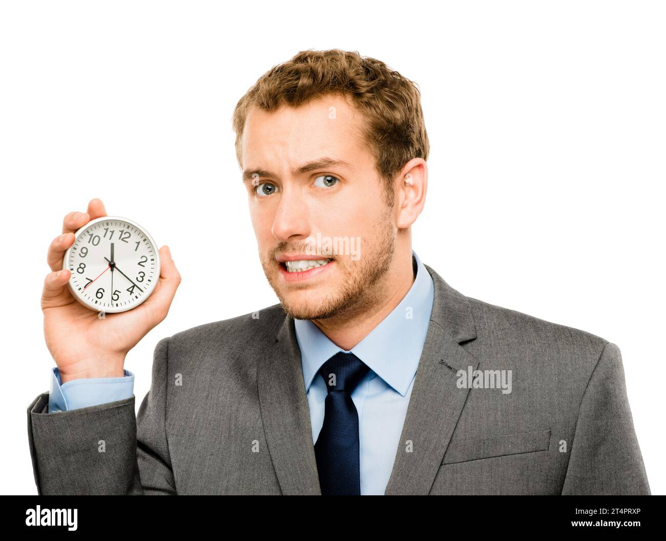 Hes always on the clock. a businessman holding a clock against a studio ...