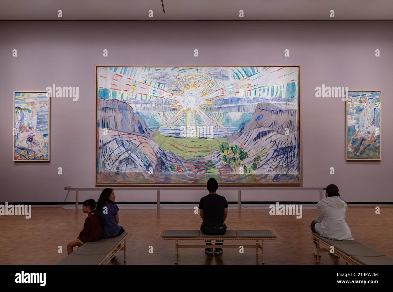 A picture of people watching one of the large paintings at the ...