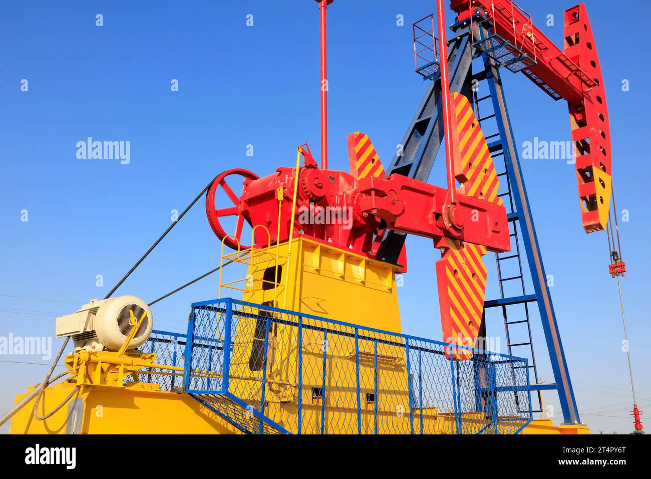 pumping unit under blue sky in oilfield Stock Photo - Alamy