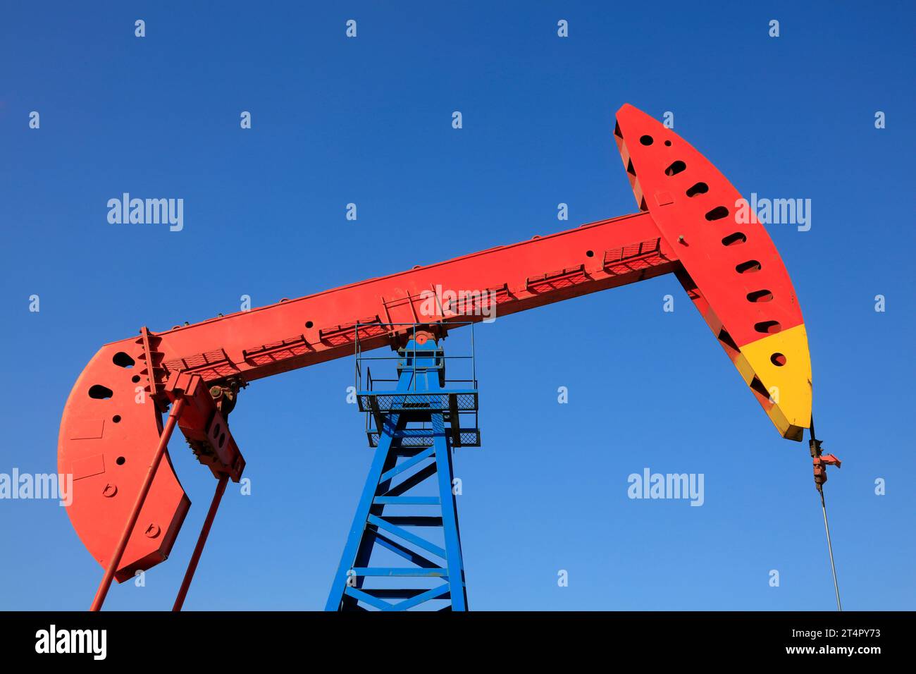 pumping unit walking beam under blue sky in oilfield Stock Photo - Alamy