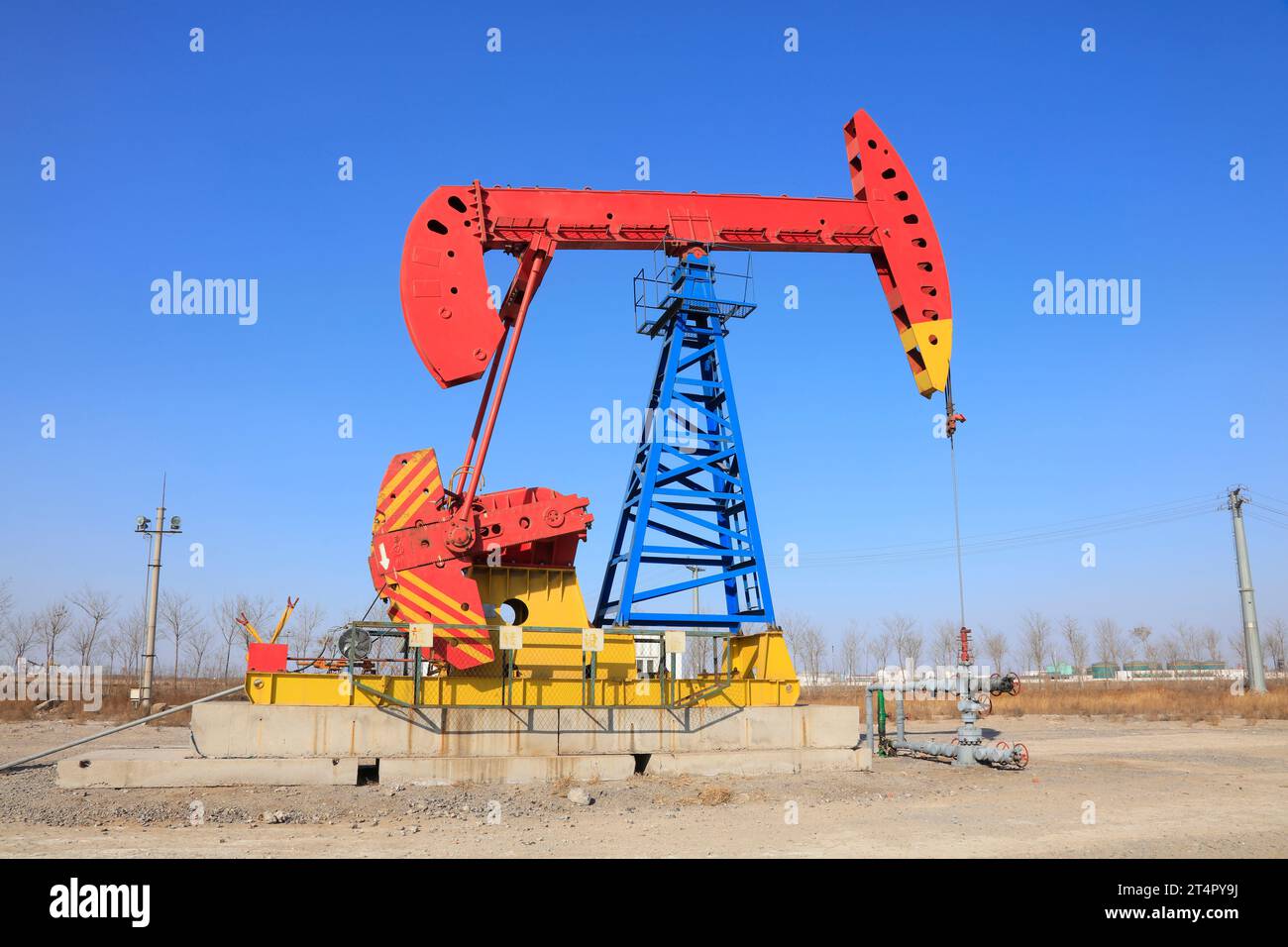 pumping unit under blue sky in oilfield Stock Photo - Alamy