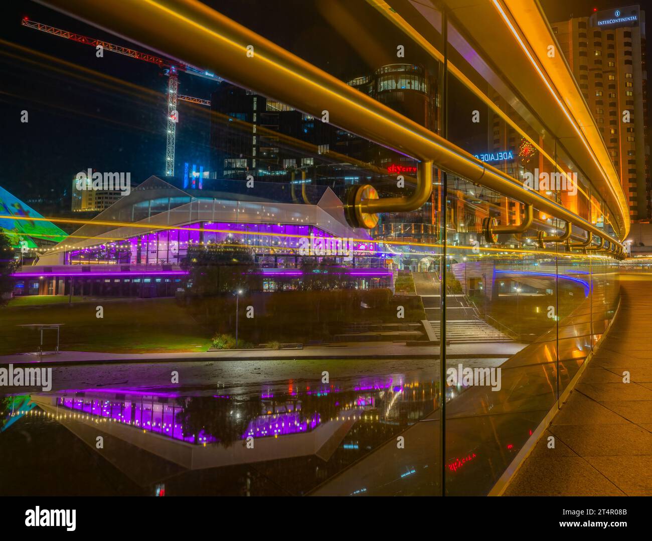view of the city skyline at night, taken from a footbridge over the ...