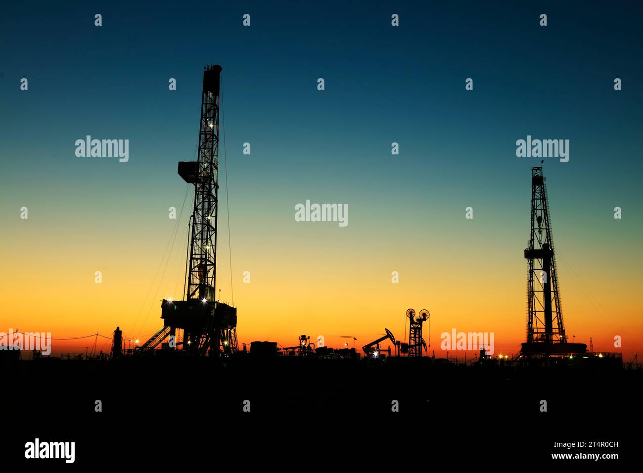 Oil drilling derrick and lights in oilfield Stock Photo - Alamy