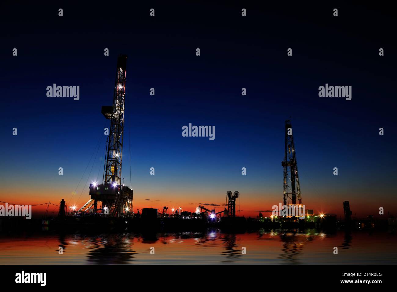 Oil drilling derrick and lights in oilfield Stock Photo - Alamy
