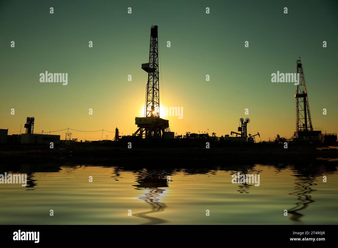 Oil drilling derrick in the sunset Stock Photo - Alamy