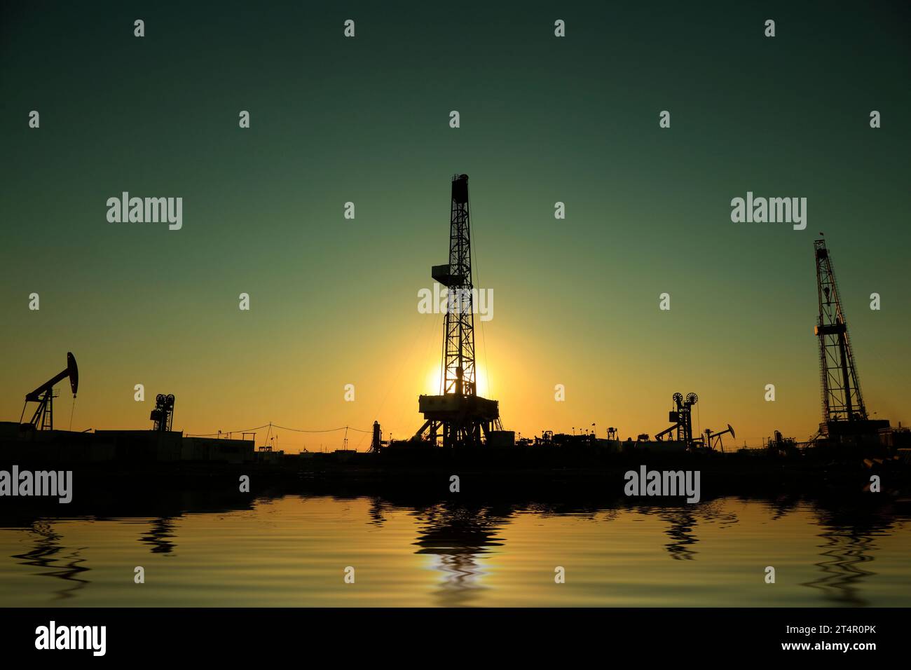 Oil drilling derrick in the sunset Stock Photo - Alamy