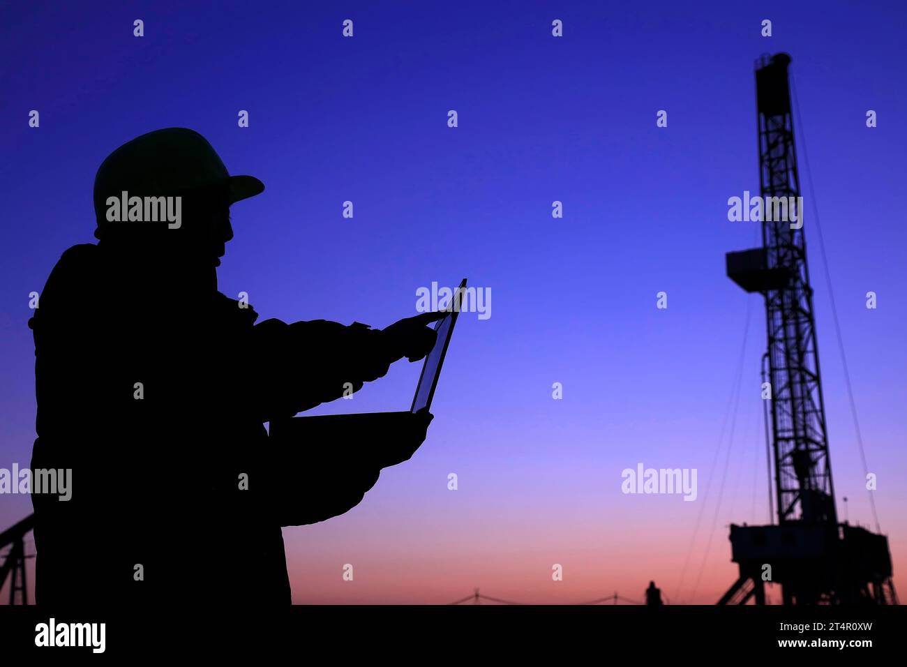 Oil drilling frame and exploration technician in a oilfield Stock Photo ...