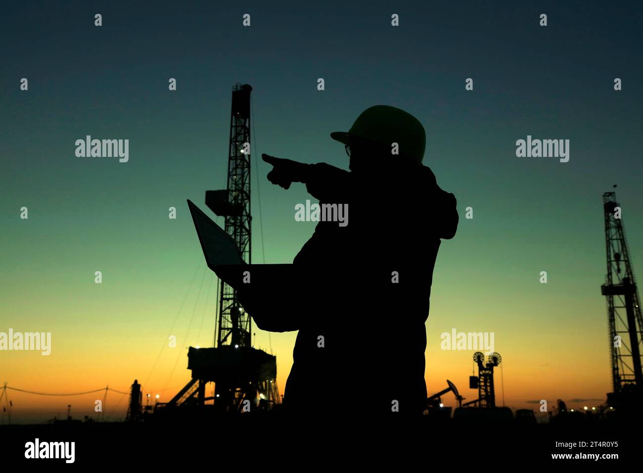Oil drilling frame and exploration technician in a oilfield Stock Photo ...