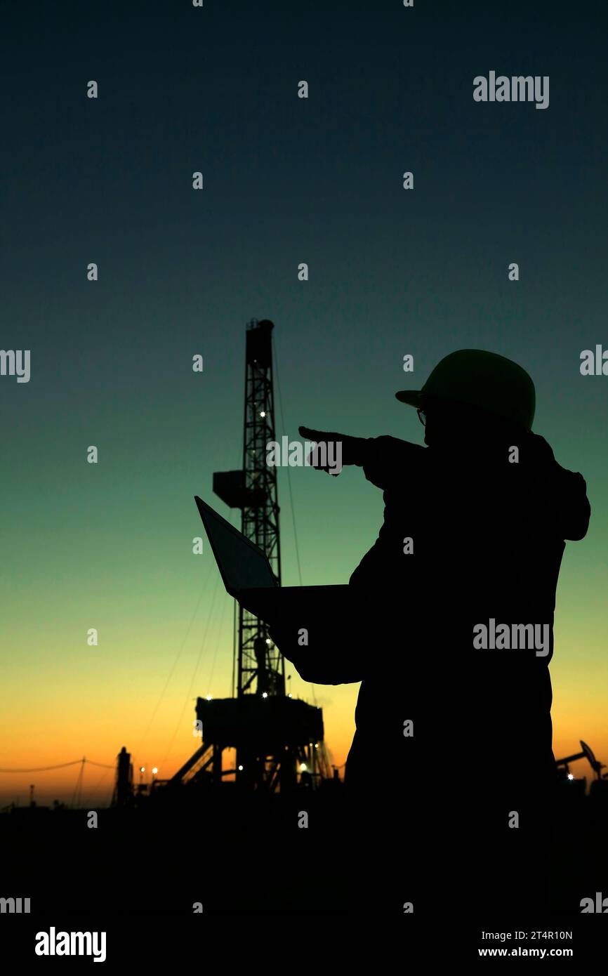 Oil drilling frame and exploration technician in a oilfield Stock Photo ...
