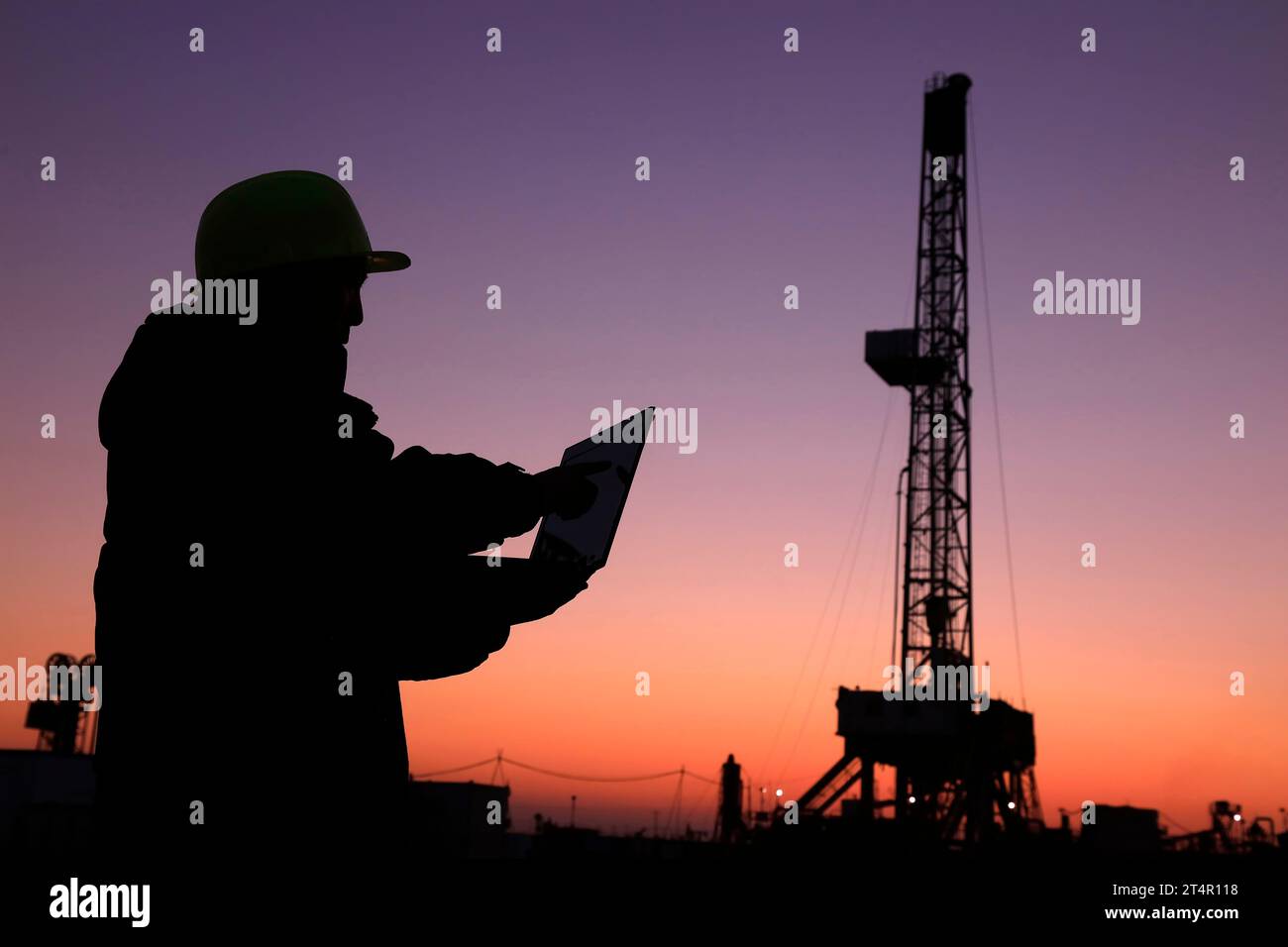 Oil drilling frame and exploration technician in a oilfield Stock Photo ...