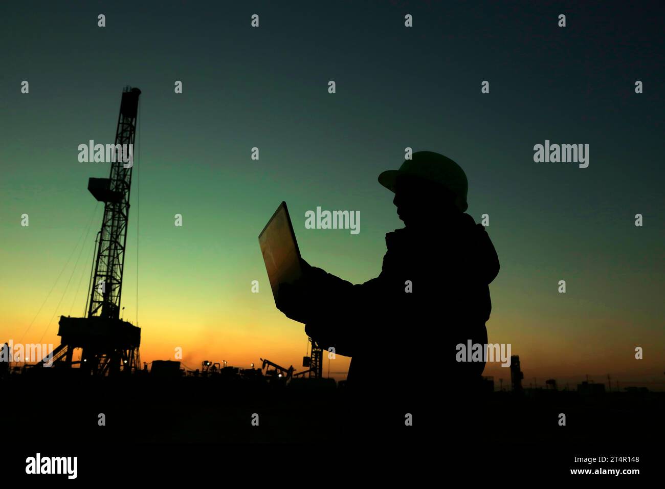 Oil drilling frame and exploration technician in a oilfield Stock Photo ...