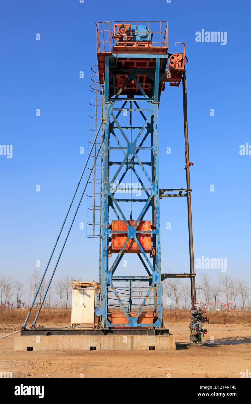 tower type pumping unit under blue sky in oilfield Stock Photo - Alamy