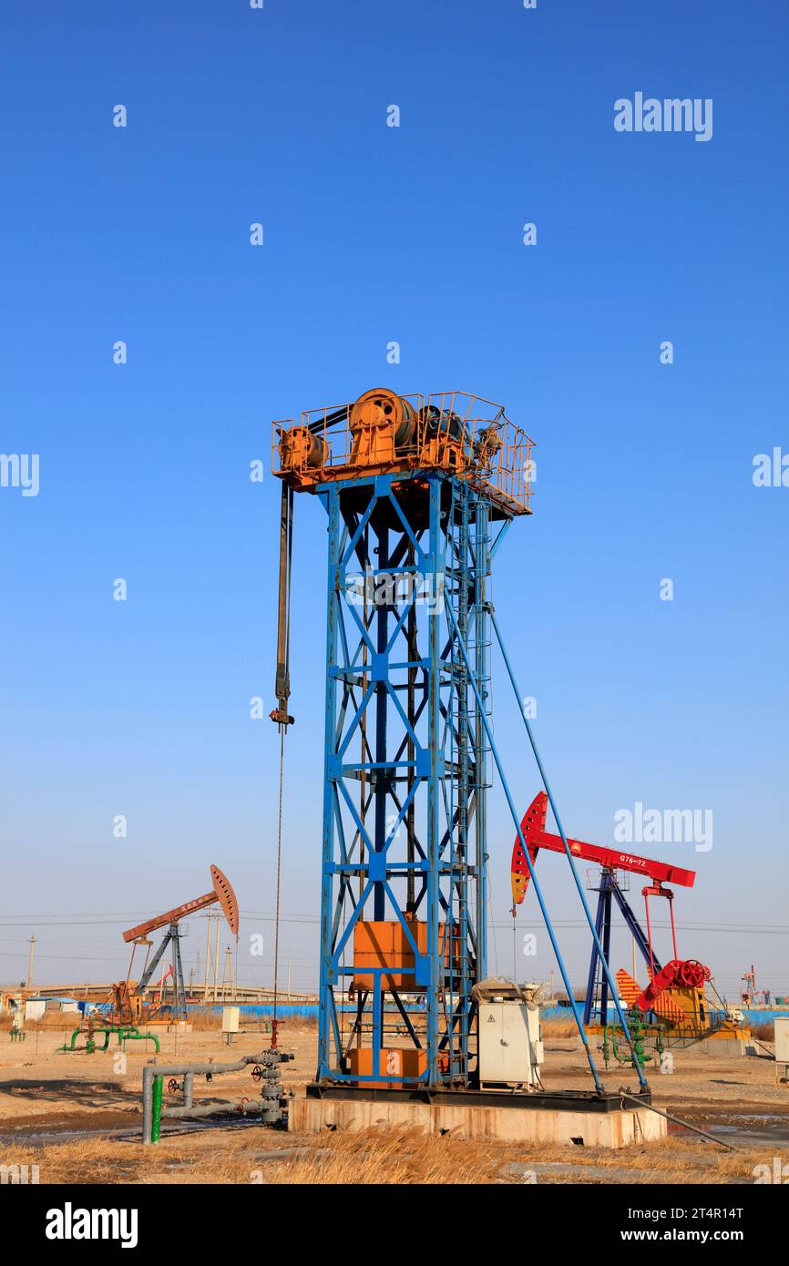 tower type pumping unit under blue sky in oilfield Stock Photo - Alamy