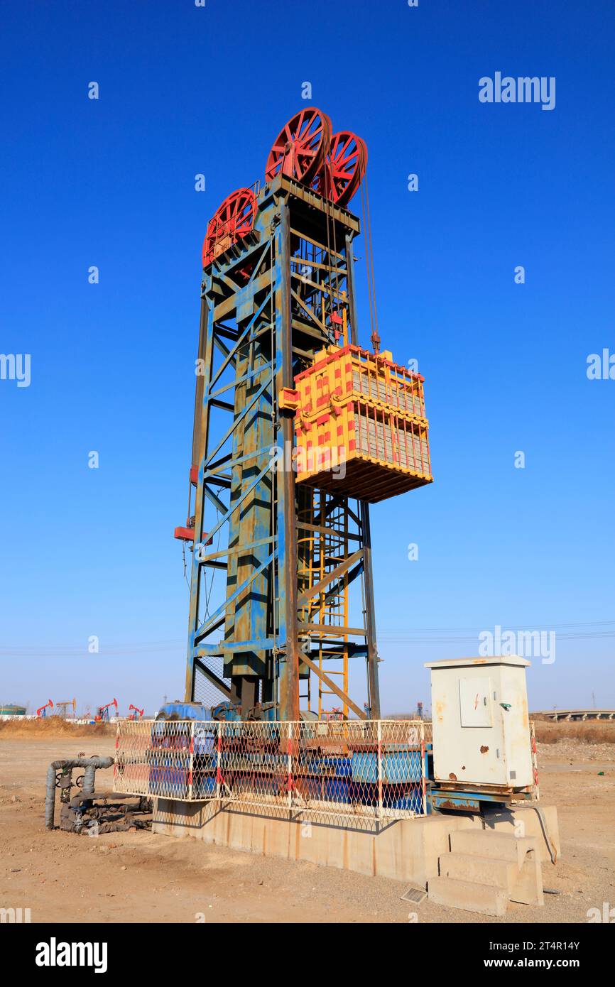 tower type pumping unit under blue sky in oilfield Stock Photo - Alamy