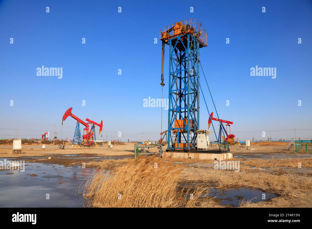 tower type pumping unit under blue sky in oilfield Stock Photo - Alamy