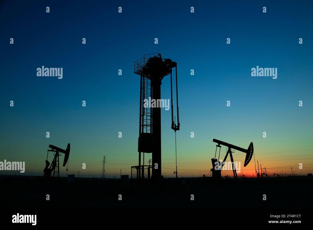 Tower type pumping unit under the setting sun in a oilfield Stock Photo ...