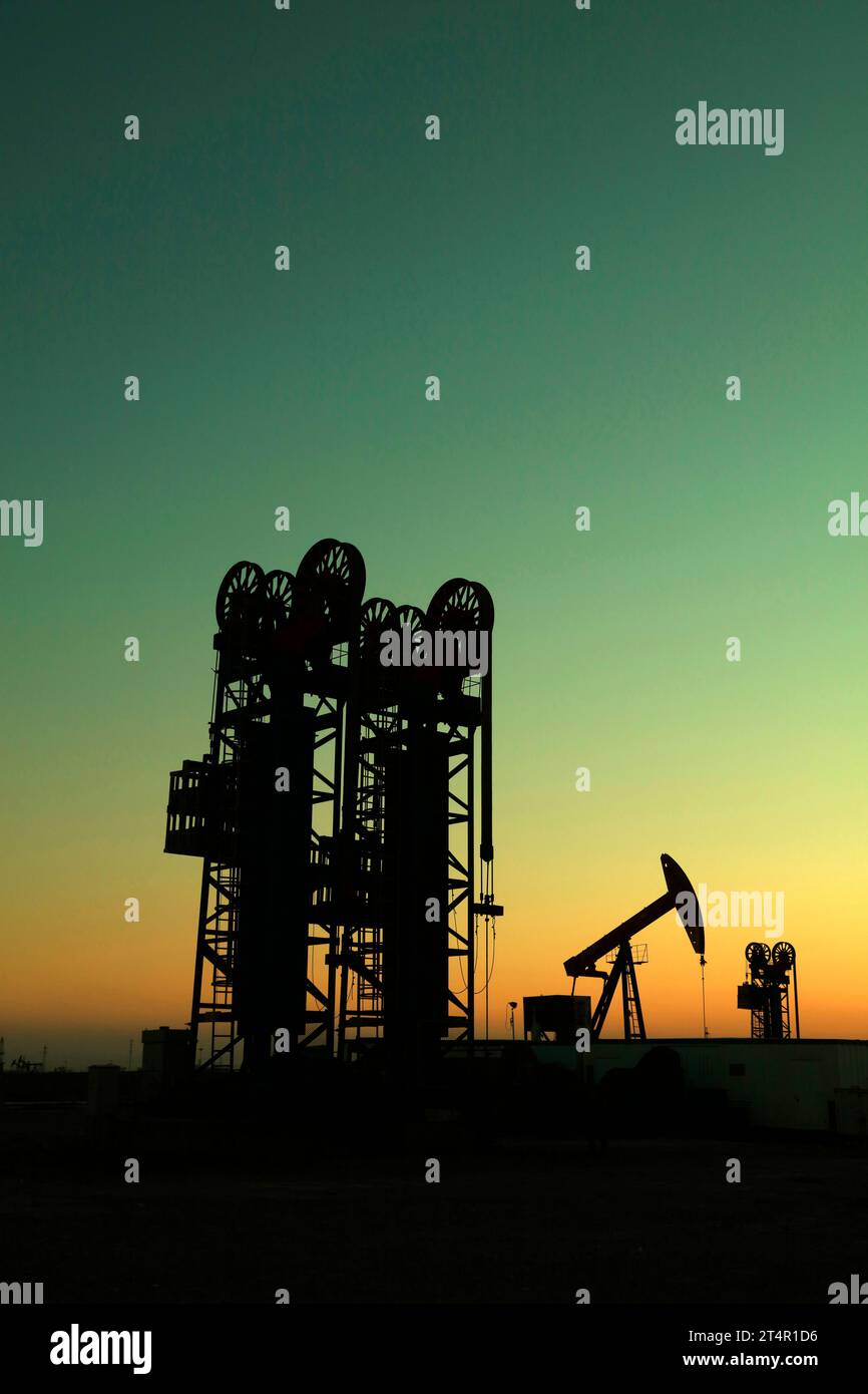 Tower type pumping unit under the setting sun in a oilfield Stock Photo ...