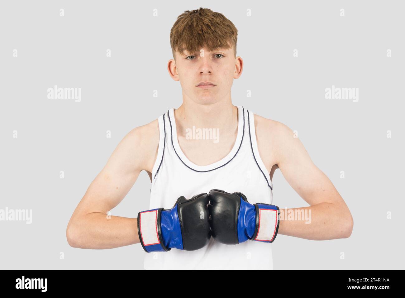 A caucasian teenage boy wearing MMA style boxing gloves posing Stock ...