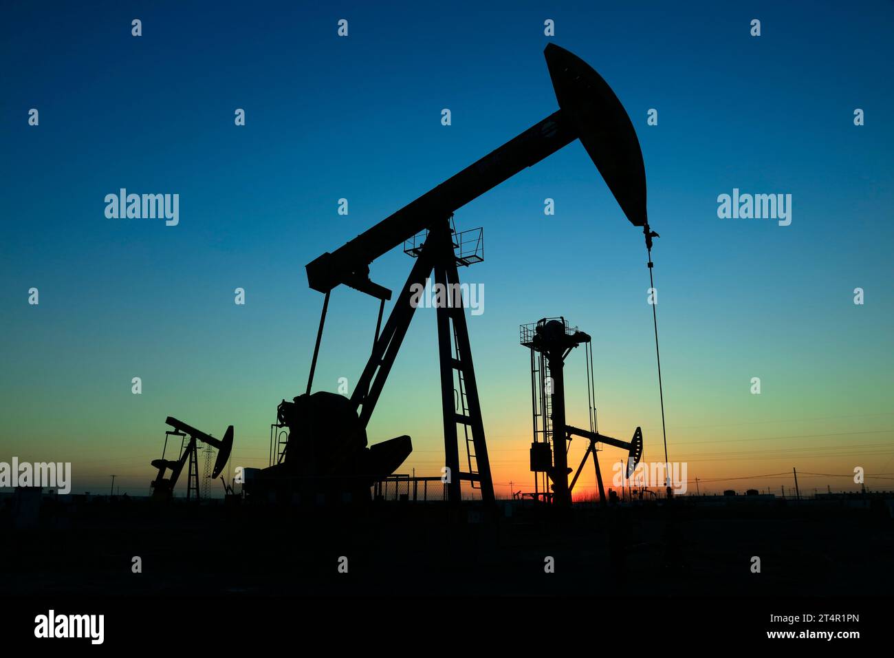 Beam balanced pumping unit under the setting sun in oilfield Stock ...