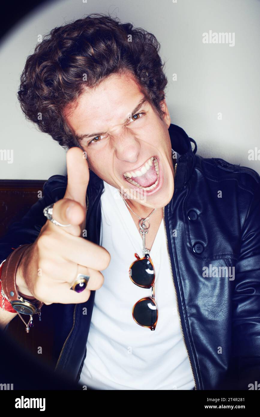 Man, gun finger and studio portrait with shouting, crazy or sign for ...