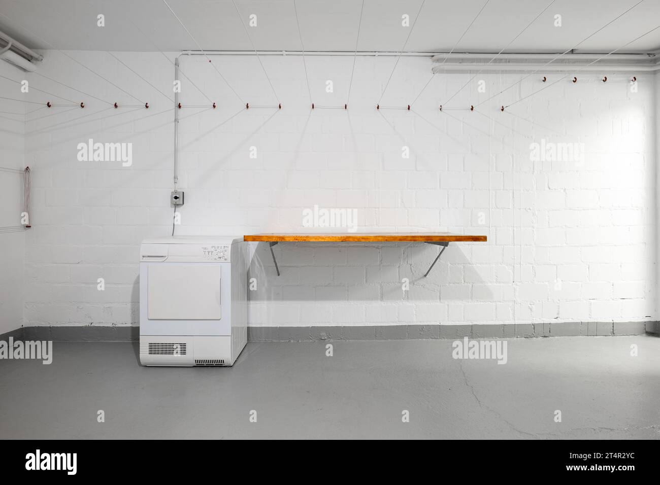 Apartment building common use empty laundry room. Empty wooden table ...