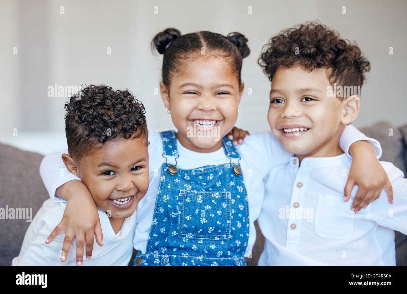 Three happy and adorable mixed race kids having fun and laughing ...