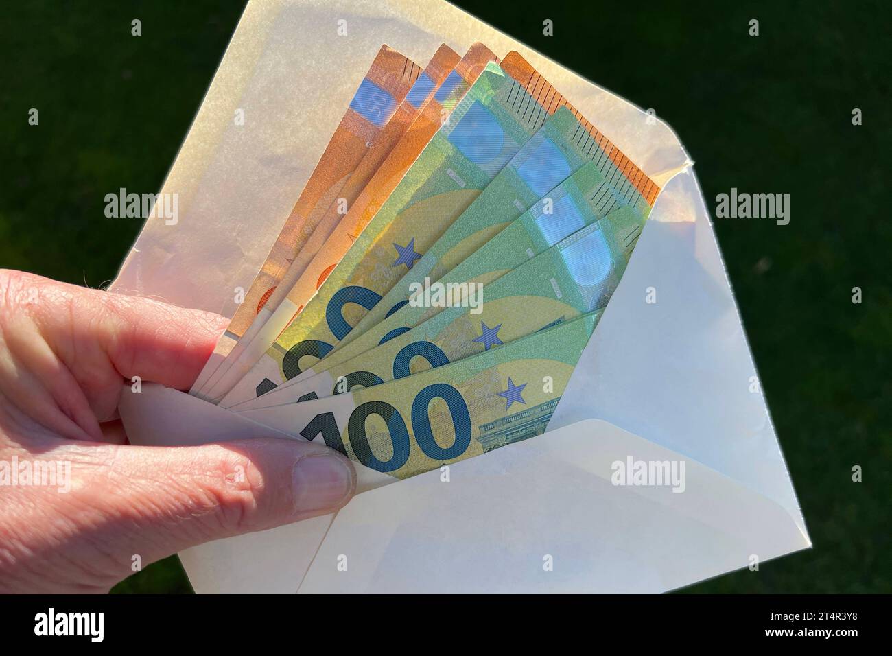 Themenbild,Symbolfoto:Hand greift Geldscheine in einem geoeffneten ...