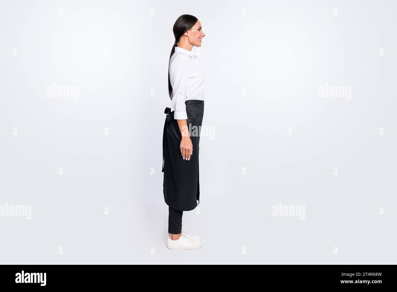 Full length body size photo of smiling waitress looking empty space ...