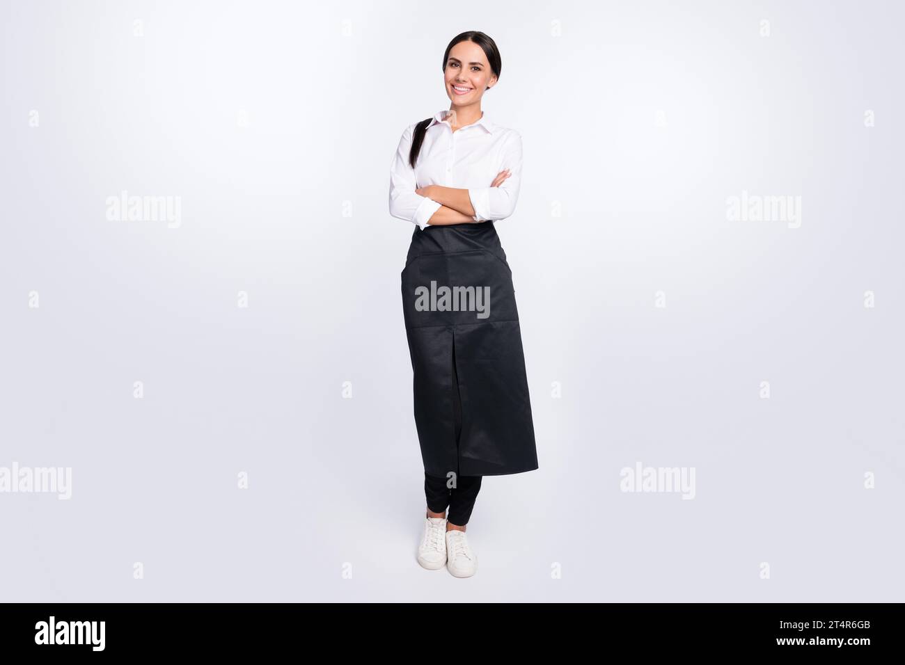 Full length body size photo of cheerful waitress with folded hands in ...