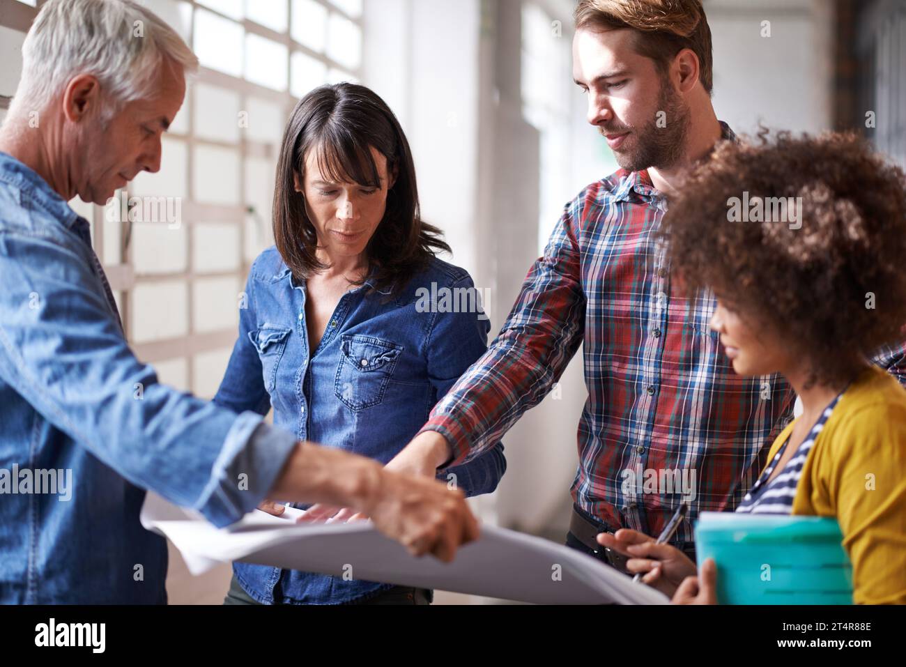 Coming up with great strategies. A group of colleagues standing in a ...