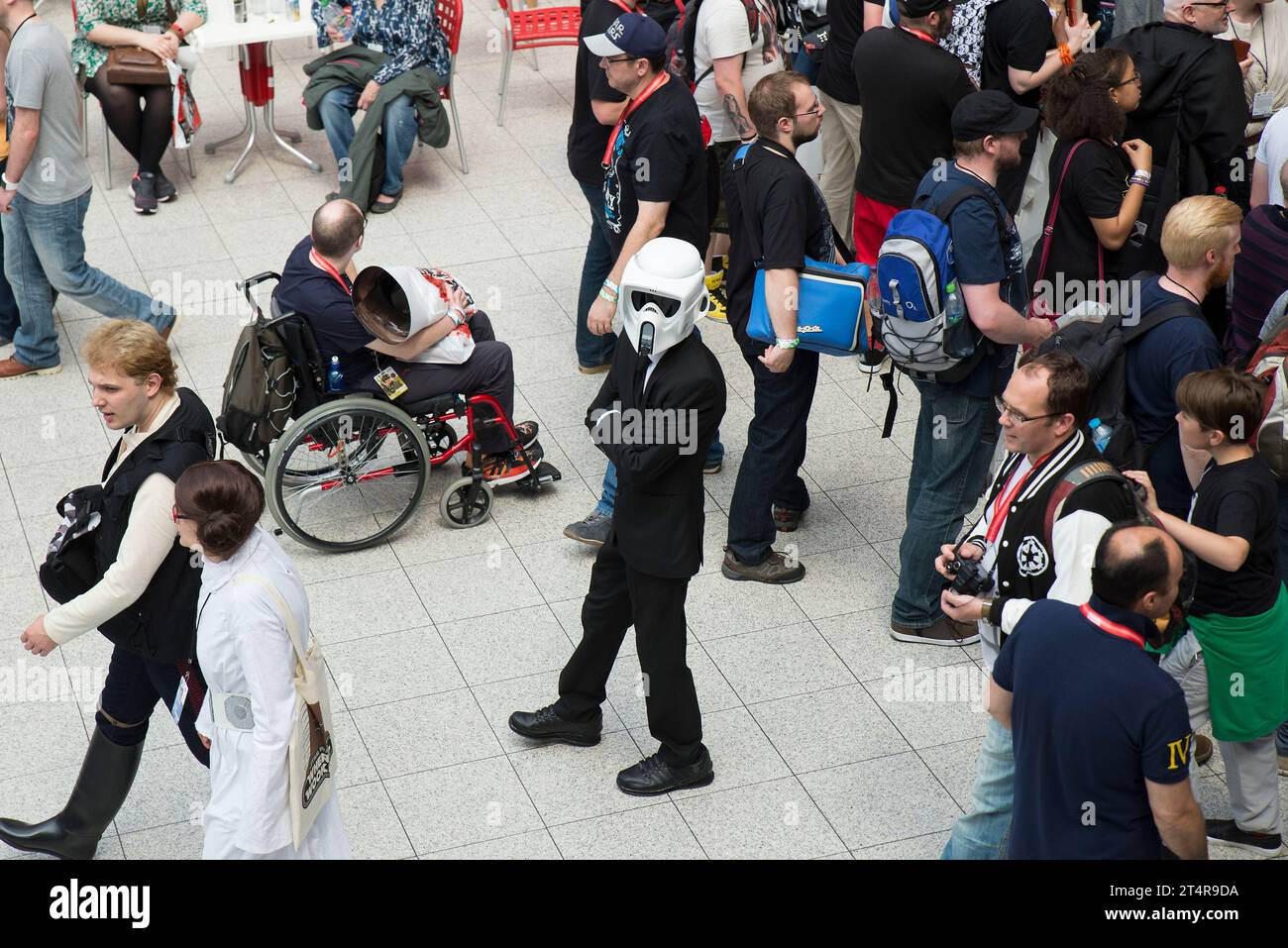 A man in a suit wears a Scout Trooper (Stormtrooper) helmet in the ...