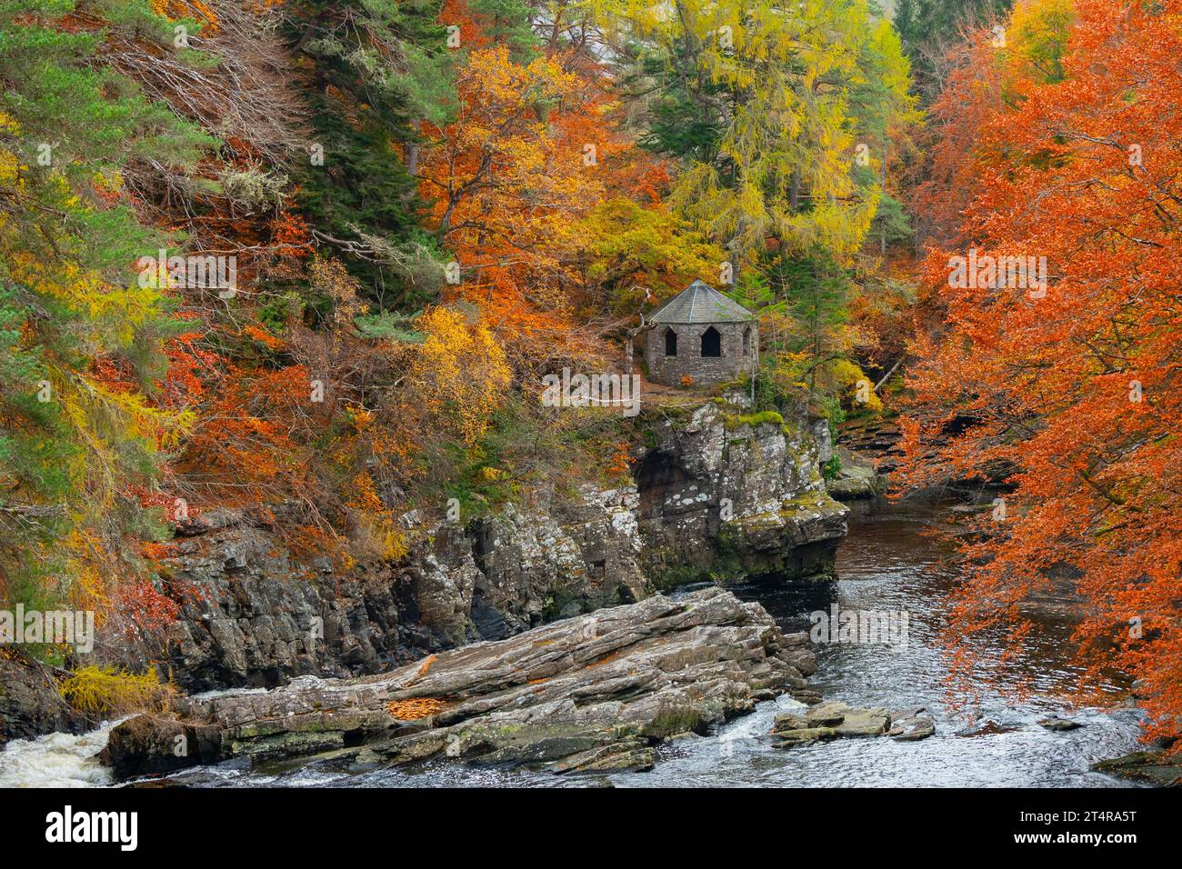 The old summer house beside River Moriston falls with autumn colours in ...