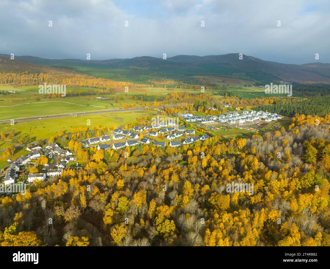 Aerial view of Kincraig village and autumn colours in woodland ...