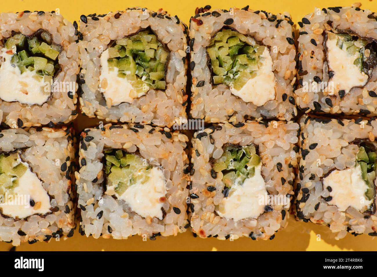 Top view of japan suchi rolls with cucumber and cream cheese on yellow ...
