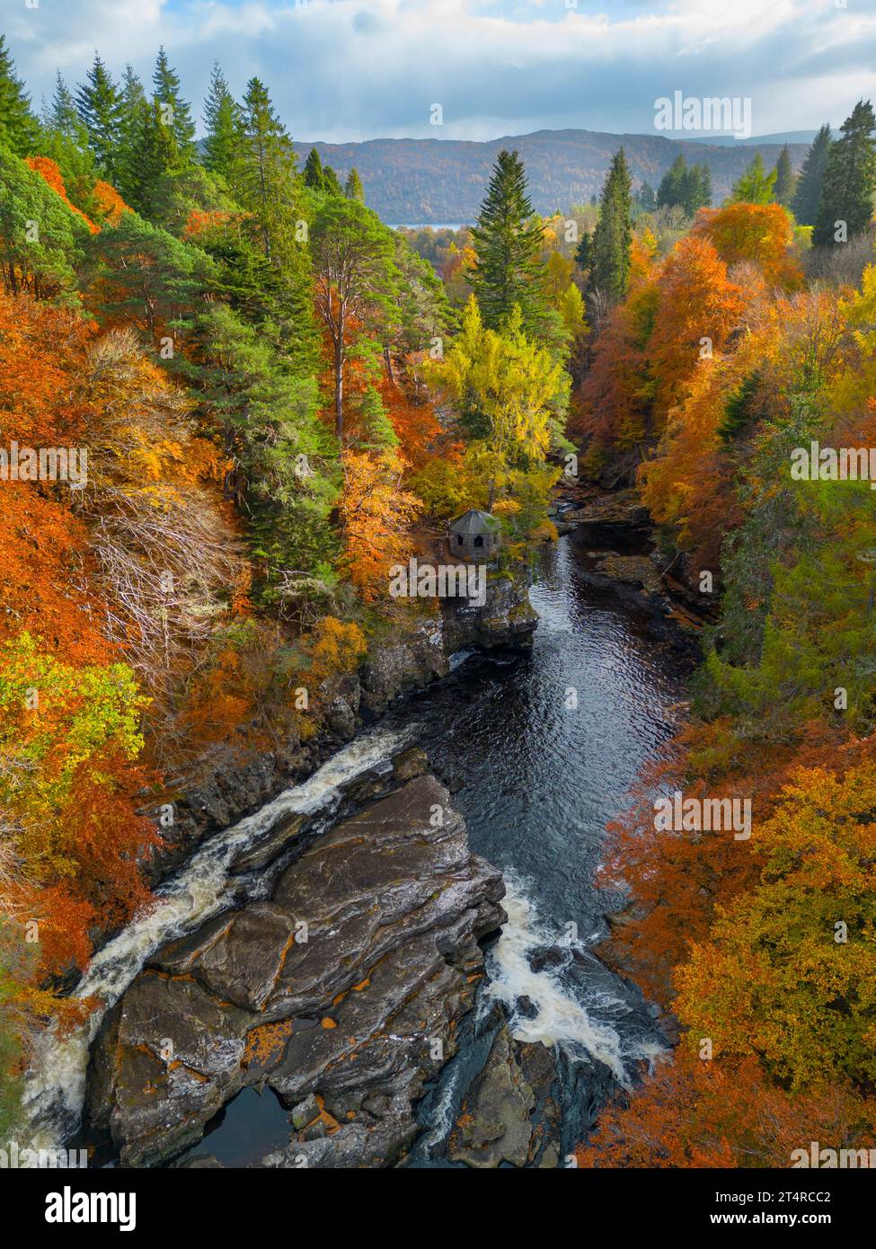 The old summer house beside River Moriston falls with autumn colours in ...