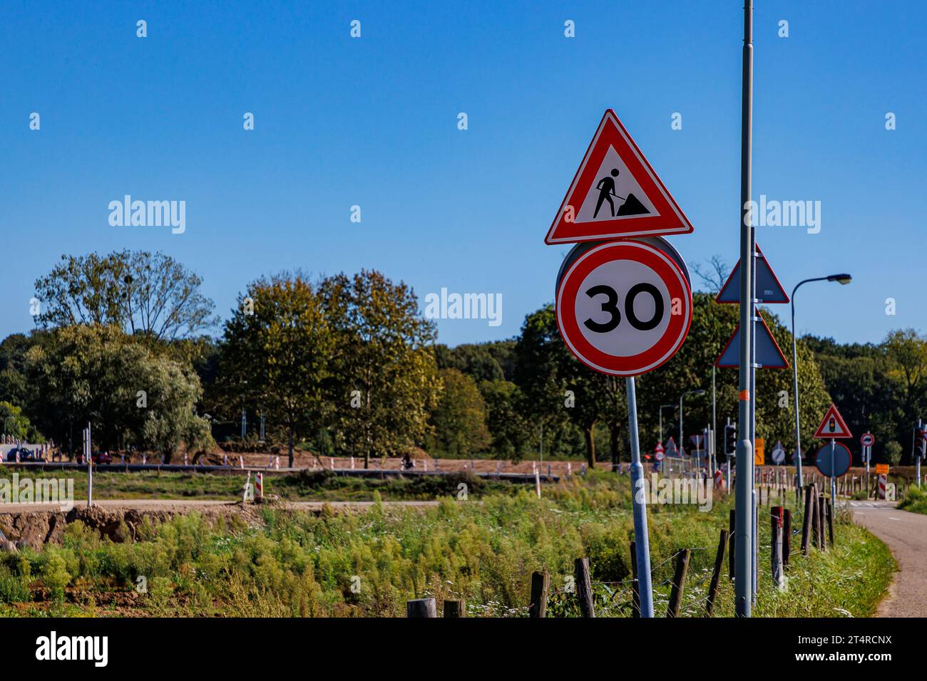 Traffic sign indicating: maximum speed 30 and men working, work zone in ...