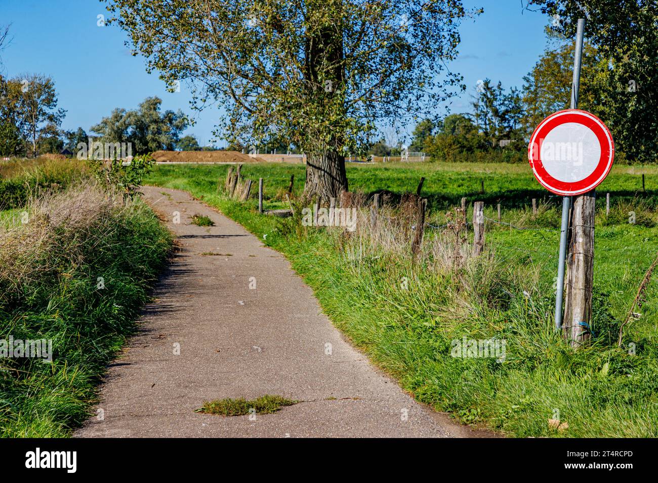 Narrow rural road with traffic sign: traffic prohibited or do not enter ...