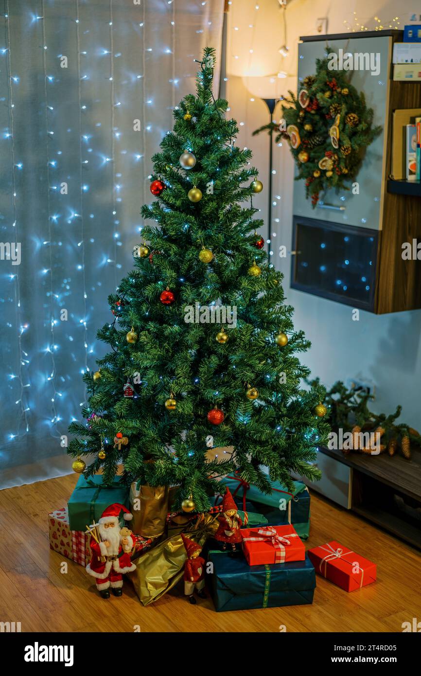 Colorful gifts with Santa Claus and an elf lie under a decorated ...