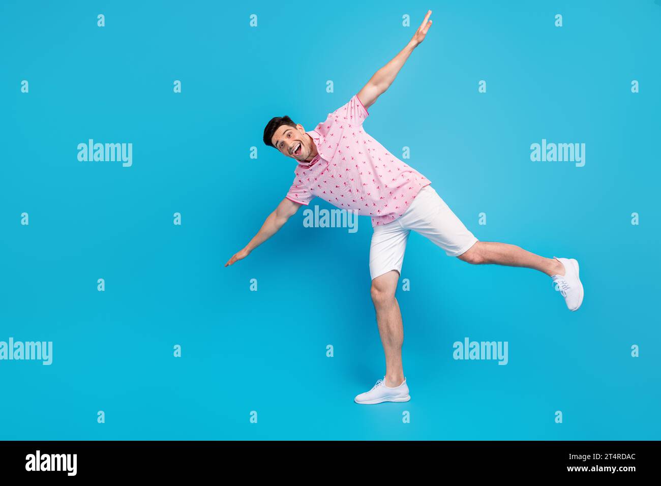Full body photo of positive crazy person stand one leg hands wings ...