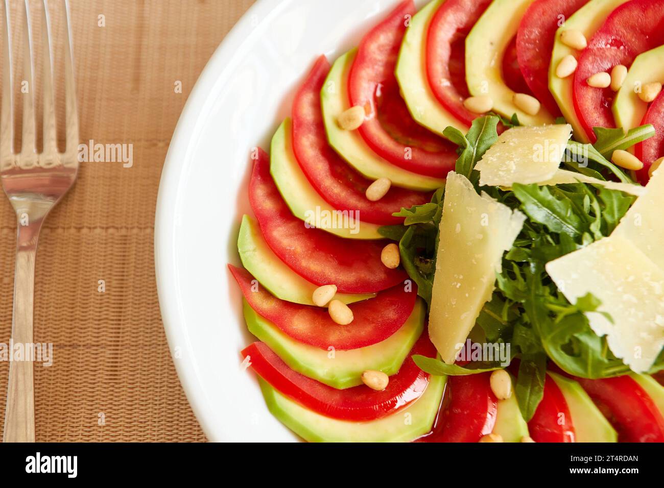 Dietary salad with zucchini, tomato, arugula and sliced parmesan ...
