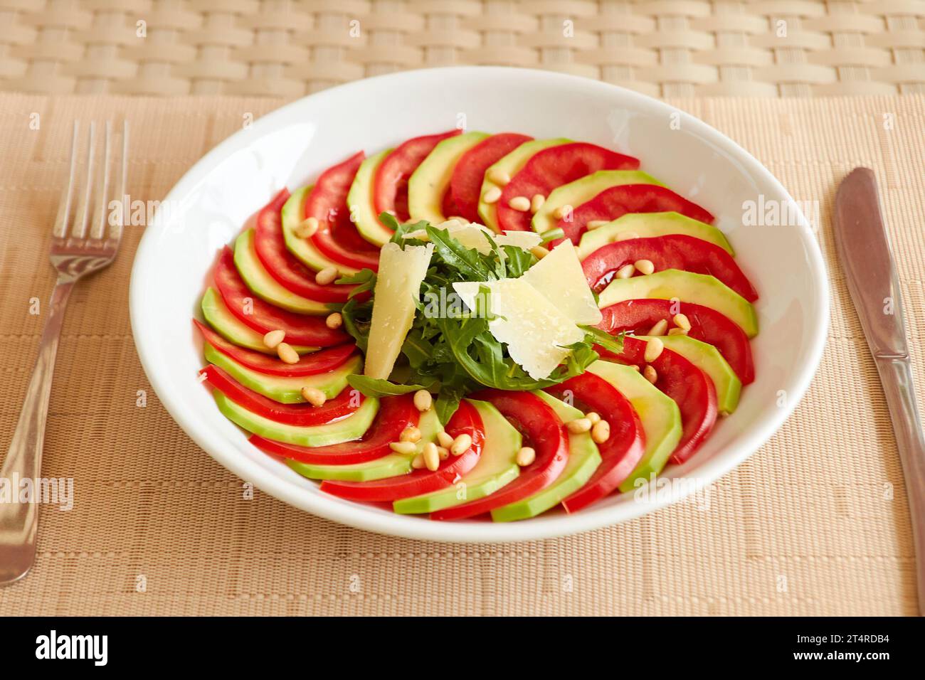 Dietary salad with zucchini, tomato, arugula and sliced parmesan ...