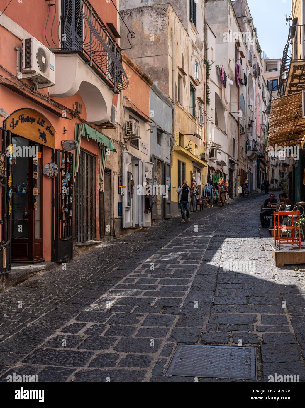 A vertical shot of a bustling alley with colorful buildings in Procida, Italy Stock Photo - Alamy